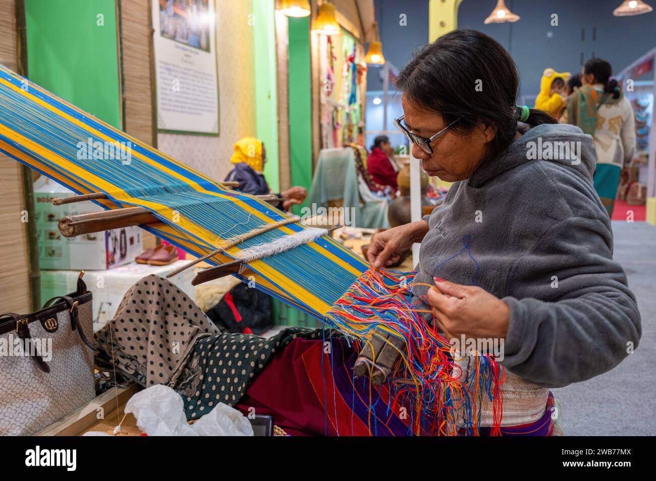 New Delhi, India. 08th Jan, 2024. An Indian artisan showcases her work ...