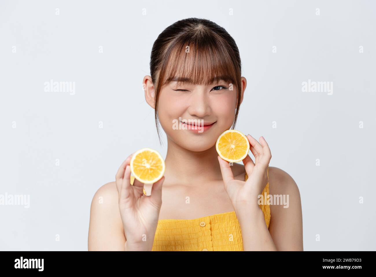 Organic cosmetics concept. A young girl with clean skin holds lemon ...