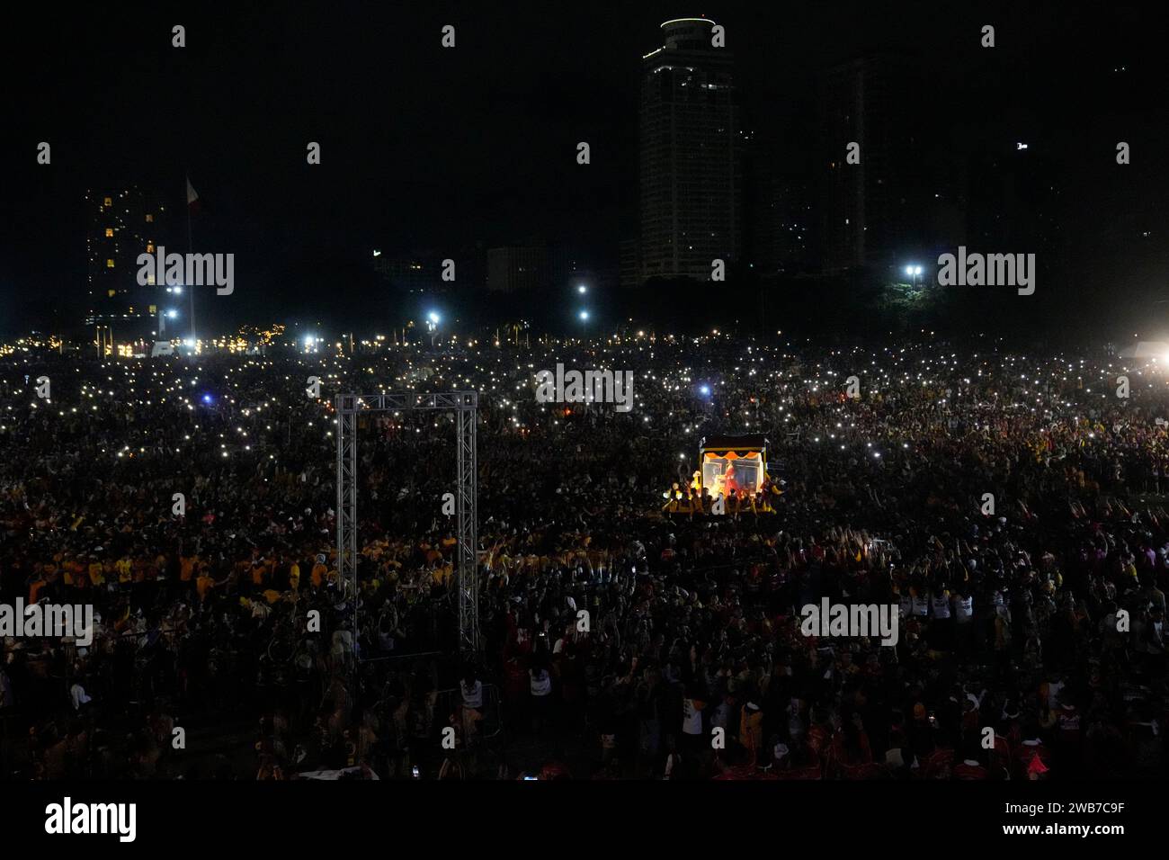 A glass-covered cart carrying the Black Nazarene is pulled by devotees ...