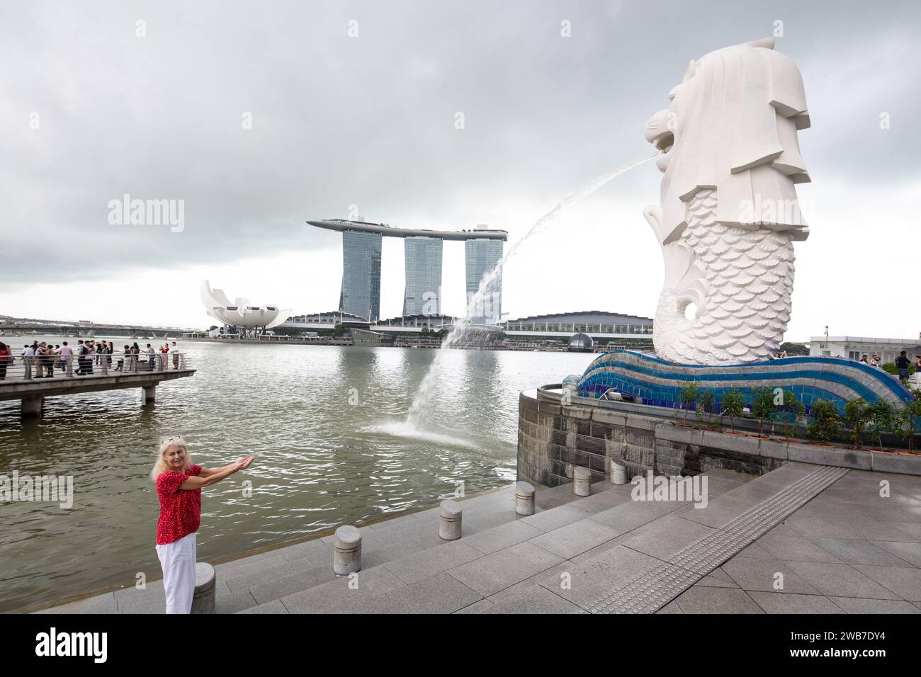 A travel caucasian tourist woman in red blouse is posing for picture ...