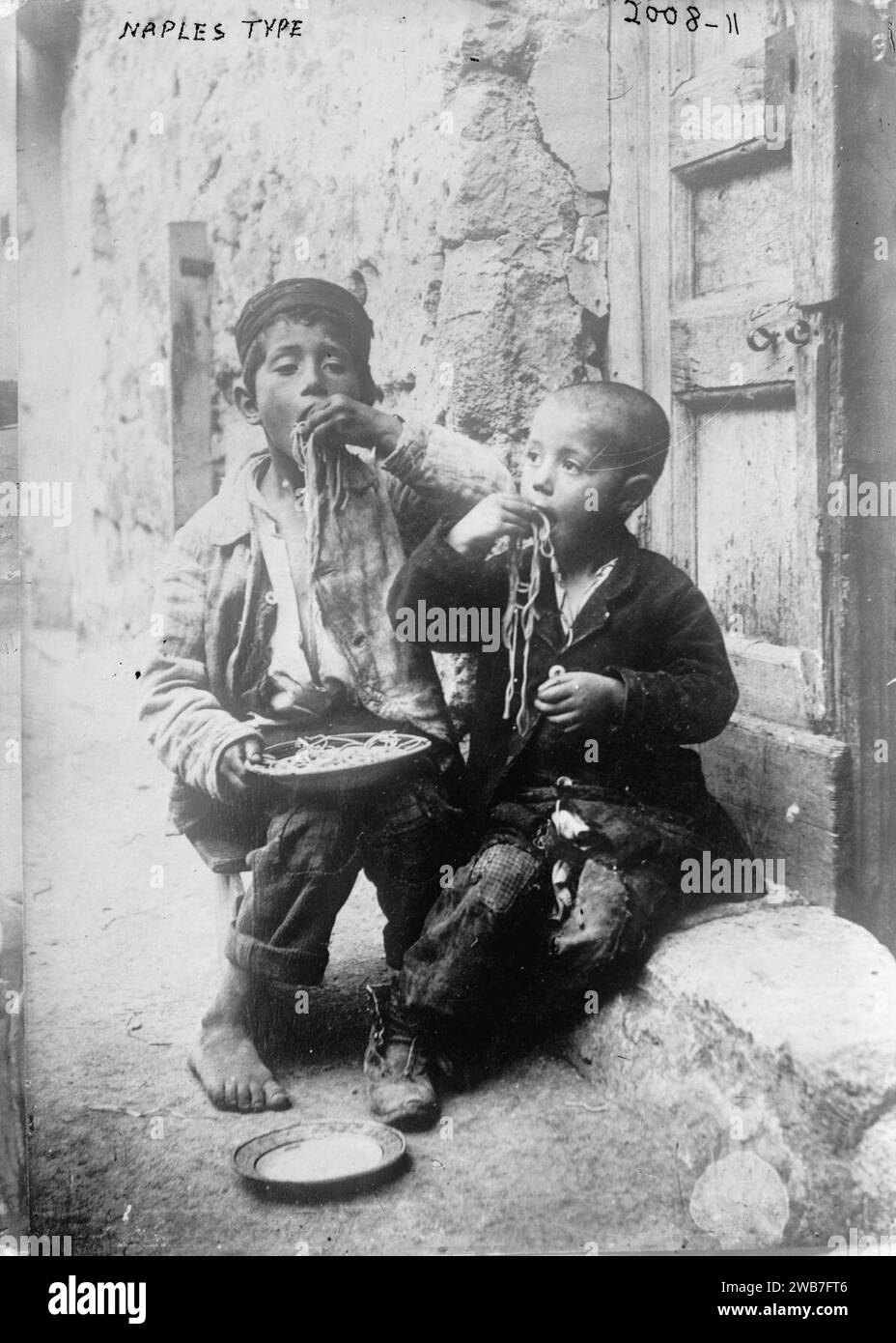 ''Naples type'' (two boys eating pasta Stock Photo - Alamy