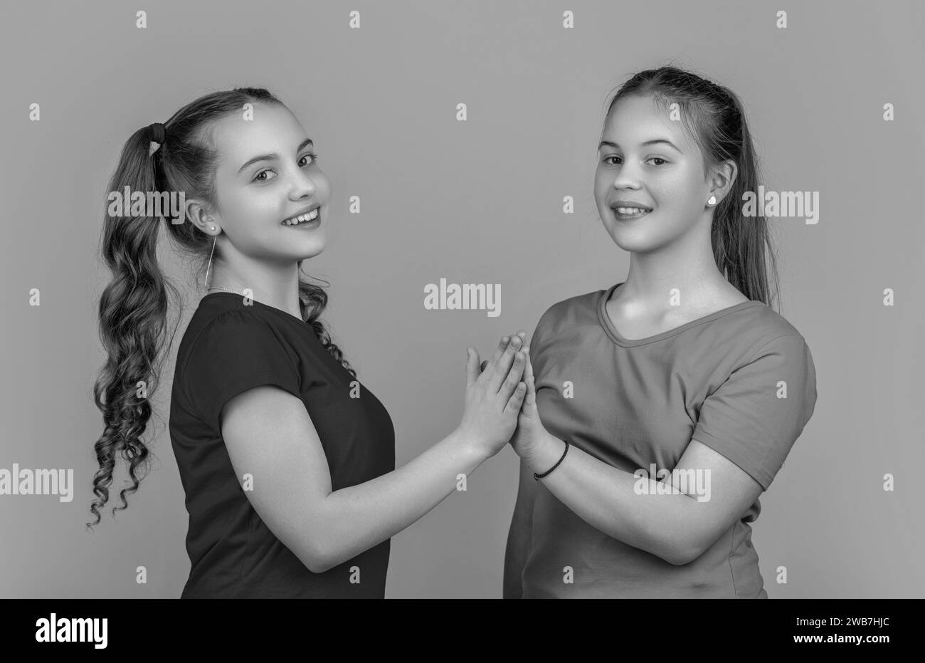 smiling children on yellow background. hello gesture Stock Photo - Alamy