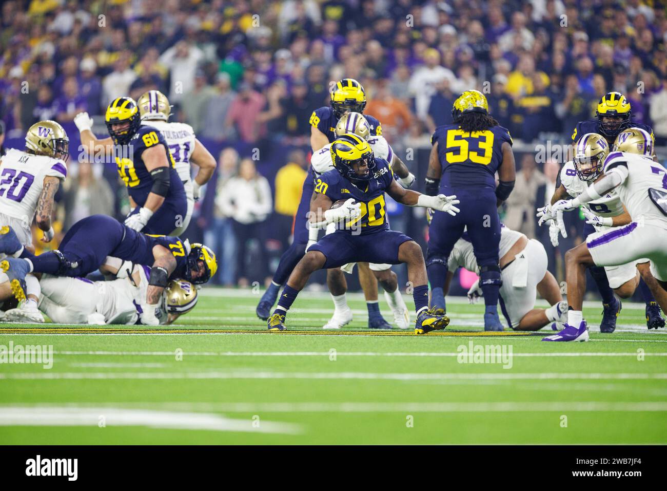 Houston, Texas, USA. 08th Jan, 2024. Michigan running back Kalel Mullings (20) runs with the ...