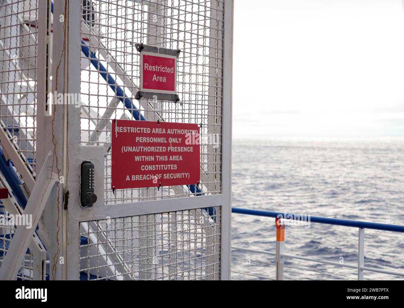 close-up, horizontal shot of two Restricted Area warning signs affixed ...