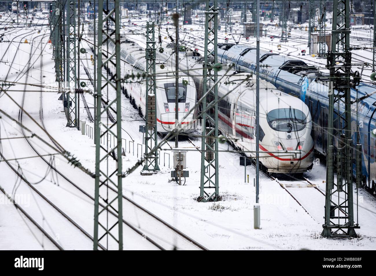 Munich, Germany. 08th Jan, 2024. Parked ICE trains stand on the snow ...