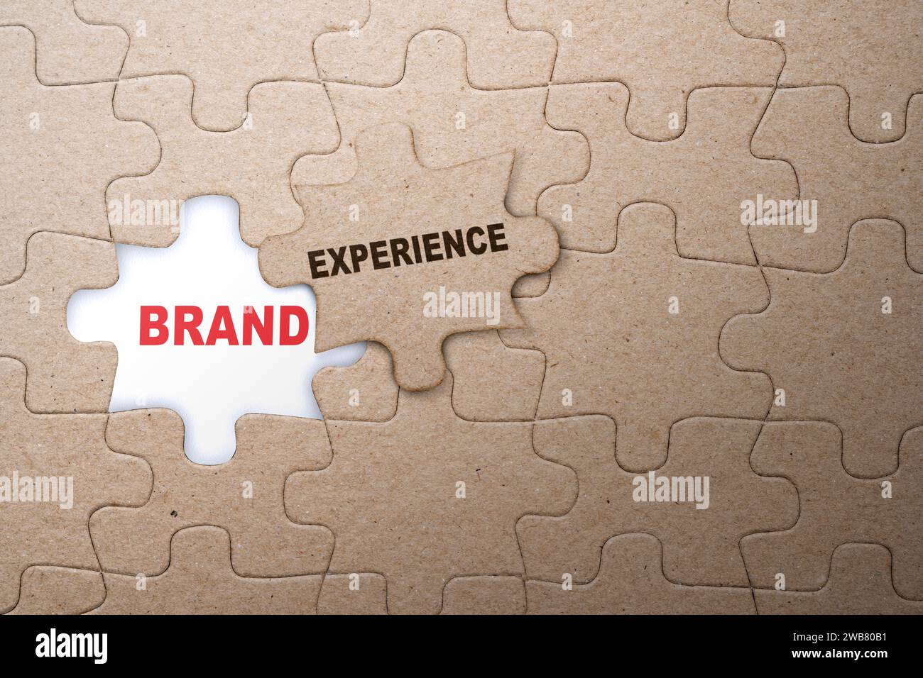 Piece of missing jigsaw puzzle with Brand Experience text over white ...