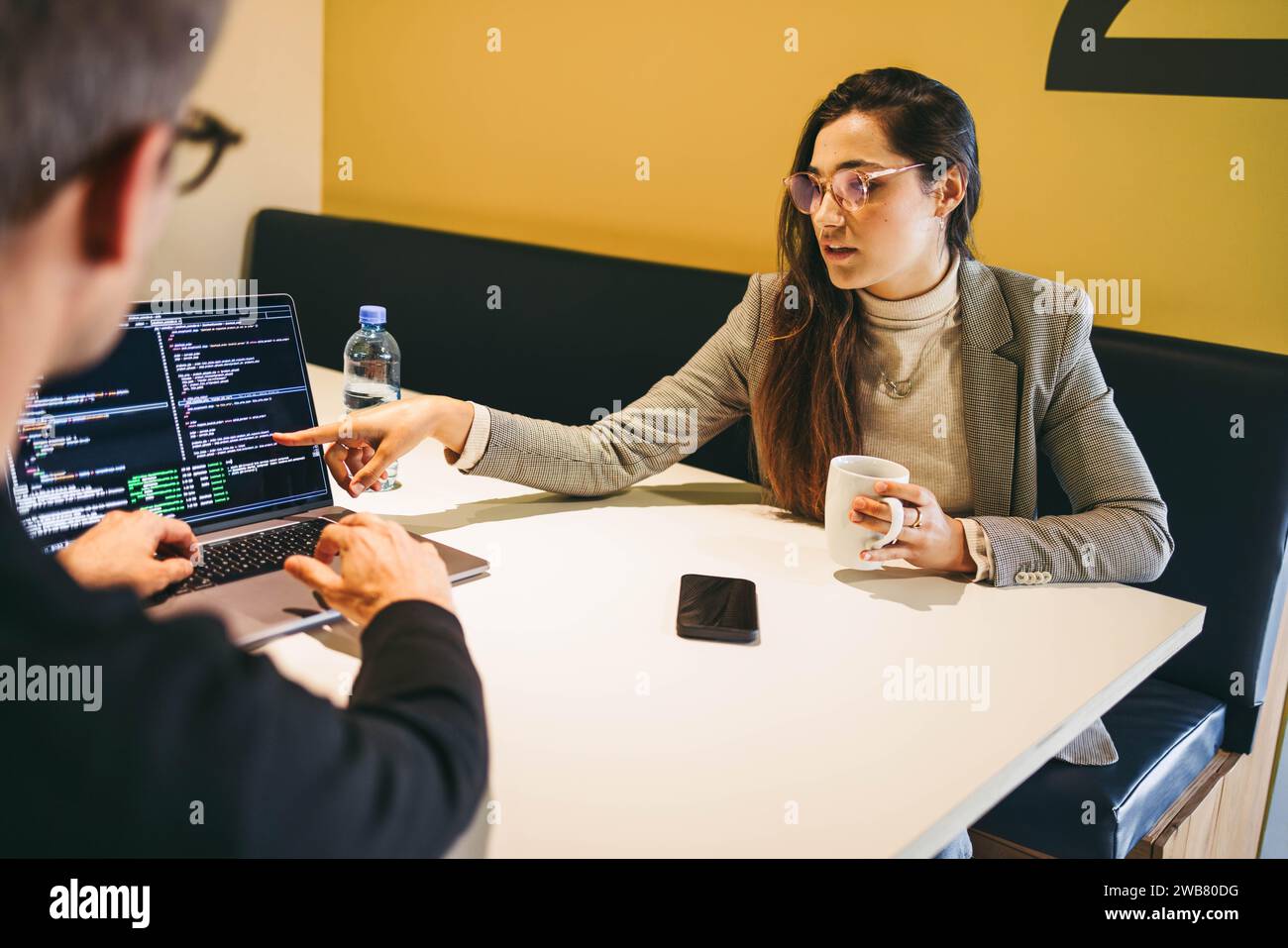 Coding Professionals A Man And A Woman Code And Collaborate In A Modern Office They Discuss