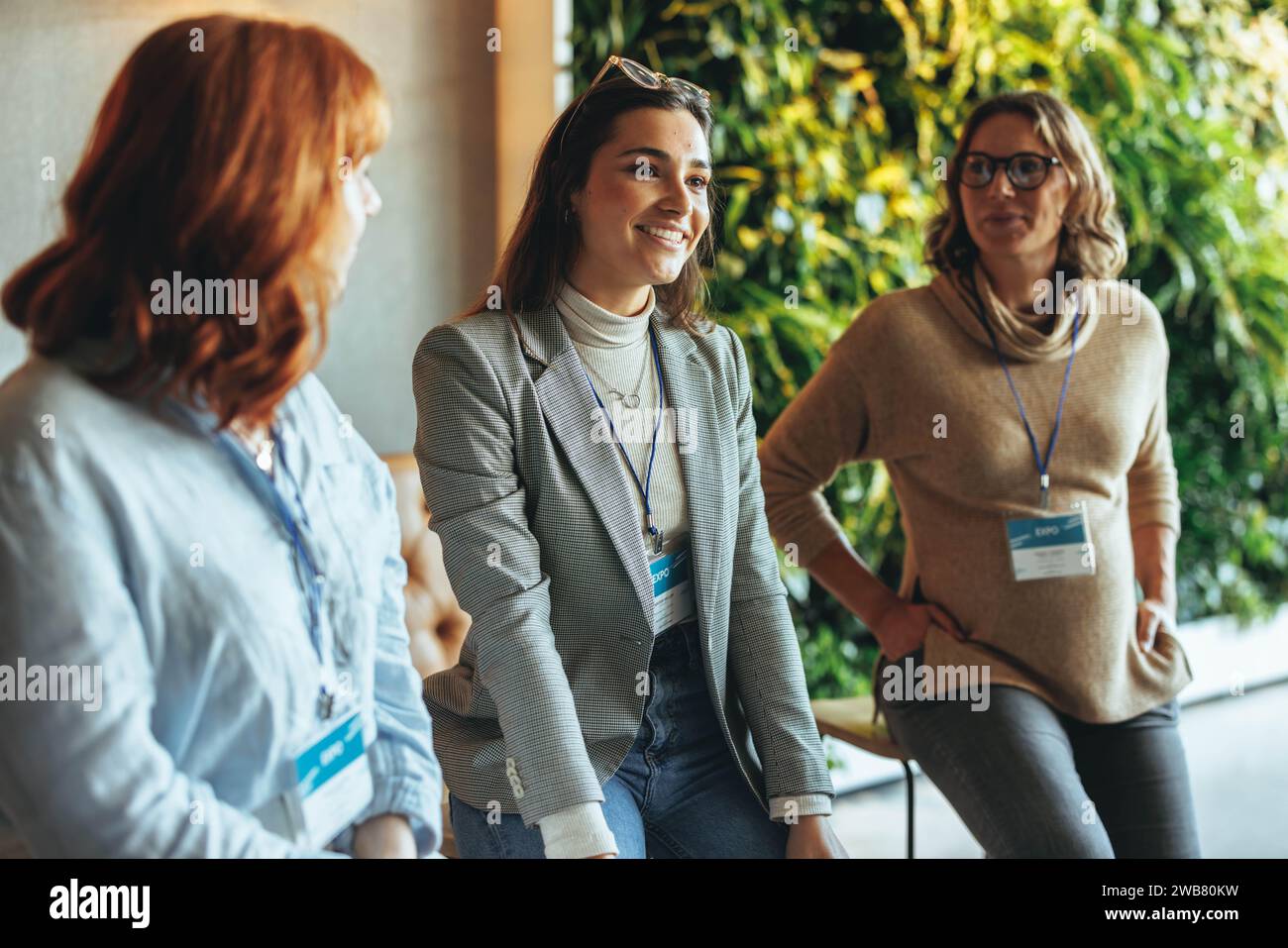 Three business women engage in a productive office panel discussion ...