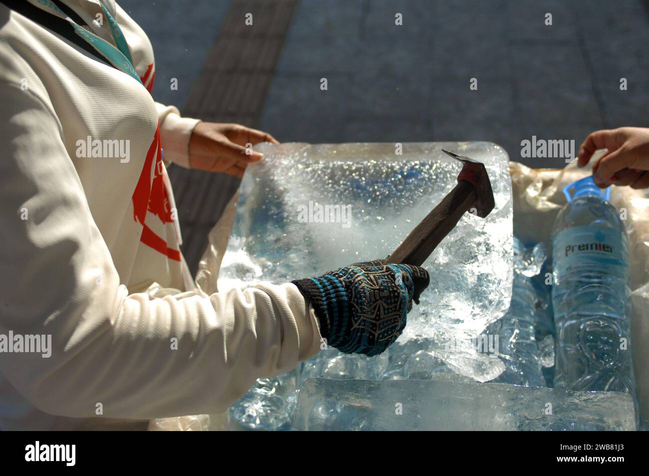 Woman breaking block of ice with an axe, Siem Reap, Cambodia Stock ...