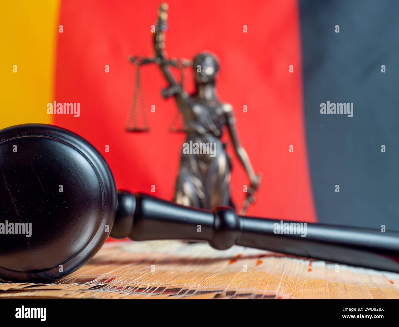 The judge's gavel lies on 50 euro bills against the background of the ...