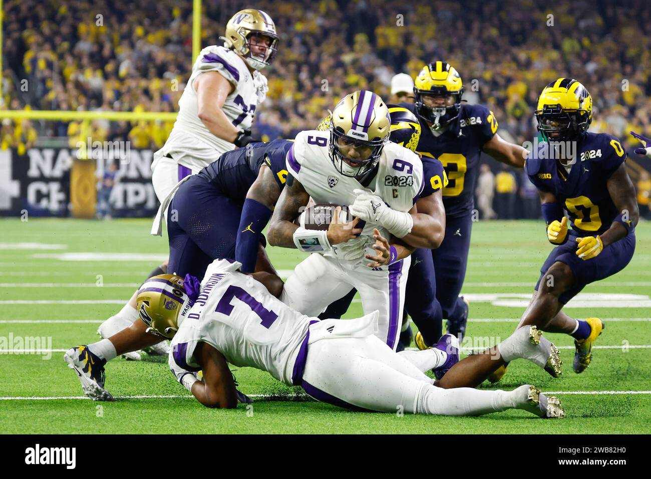 January 8, 2024: Washington Huskies quarterback Michael Penix Jr. (9) is tackled by Michigan ...
