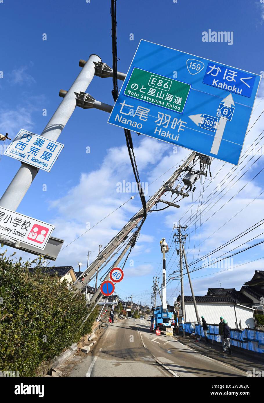 Traffic signs and utility poles are tilted due to soil liquefaction ...