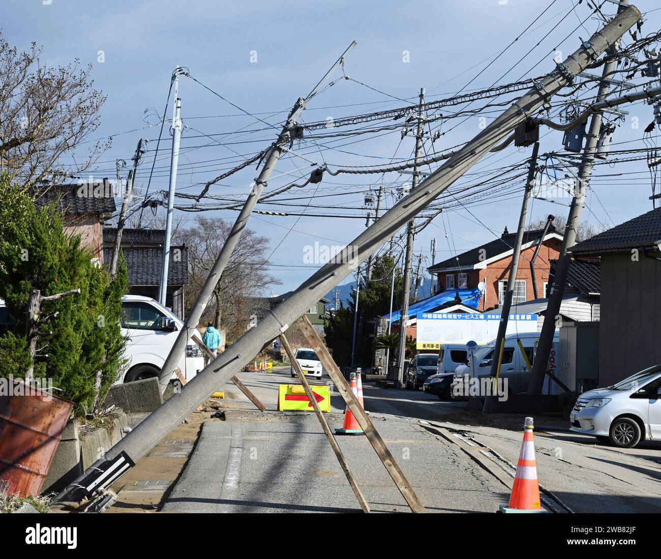 Traffic signs and utility poles are tilted due to soil liquefaction ...