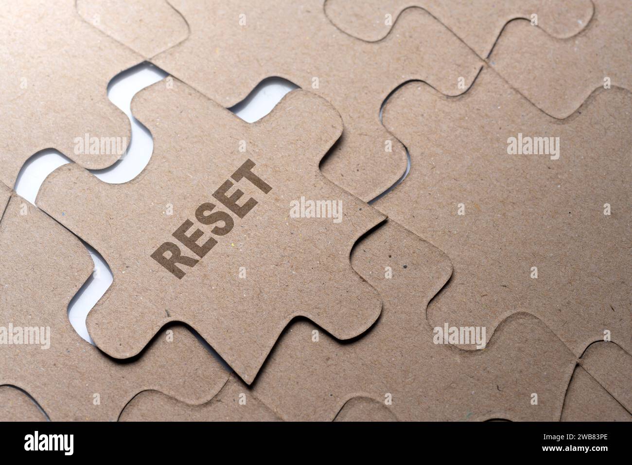 Piece of missing jigsaw puzzle with Reset text over white background ...