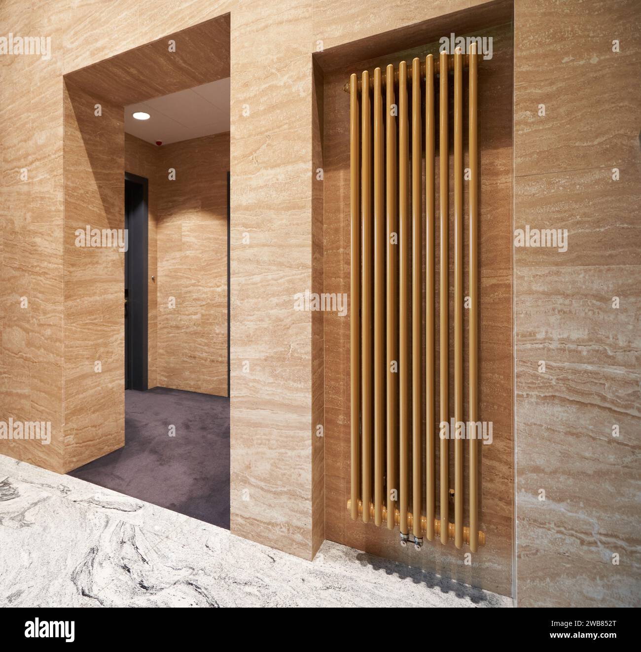 Trendy vertical heating radiator on the wall in the interior Stock ...