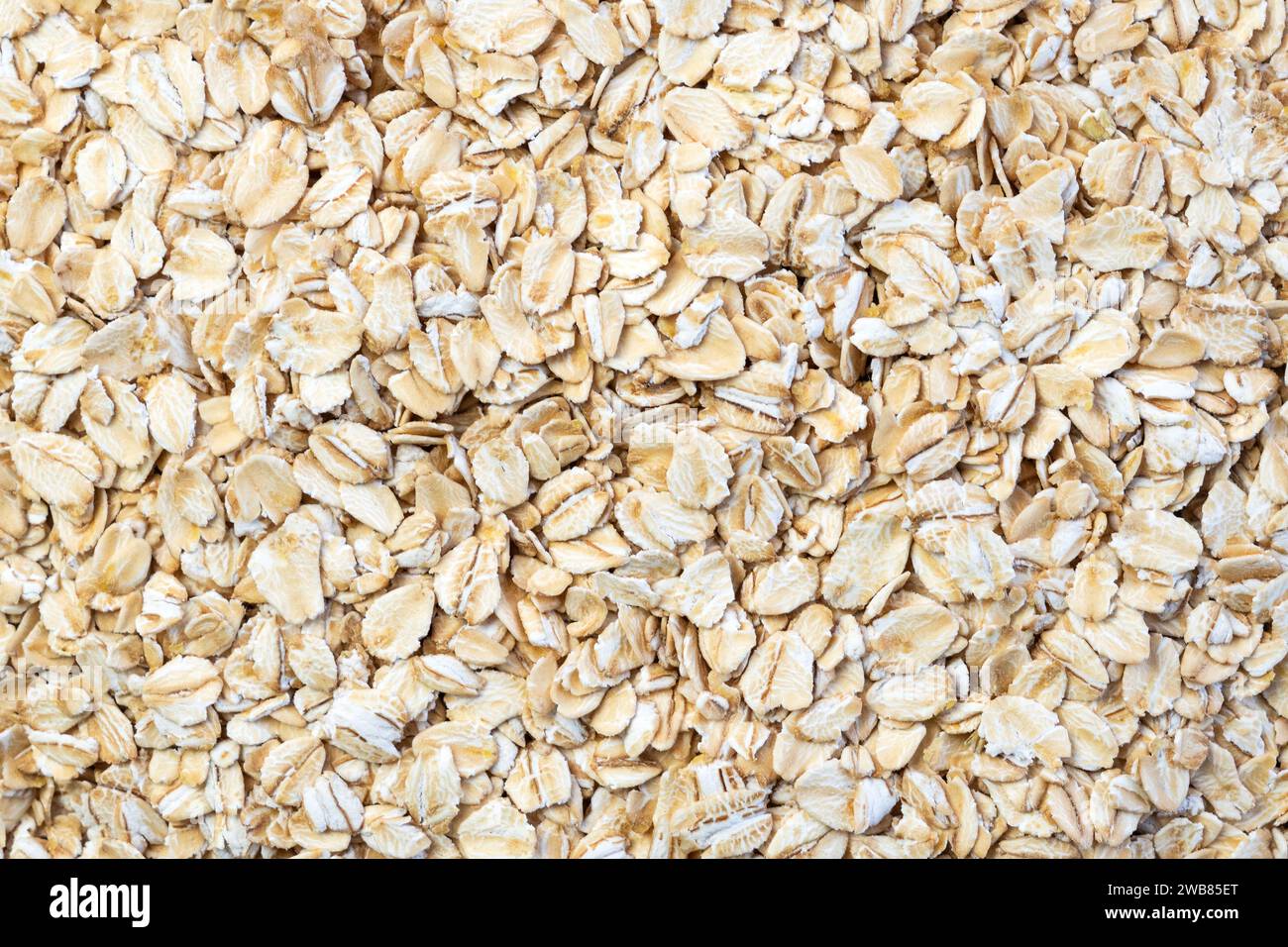 Rolled oat, oat flakes background or texture. Close up, directly above ...