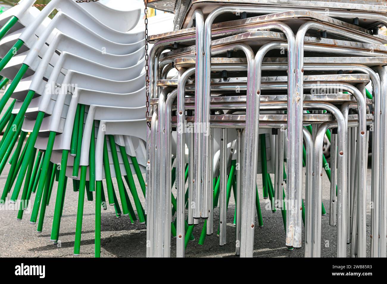 Stainless steel chairs stacked in a row on a street terrace Stock Photo ...