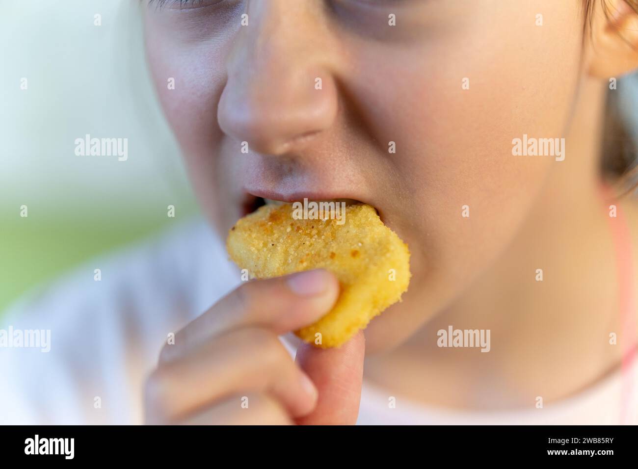 Cheerful people holding fried chicken. close-up of nuggets in mouth ...