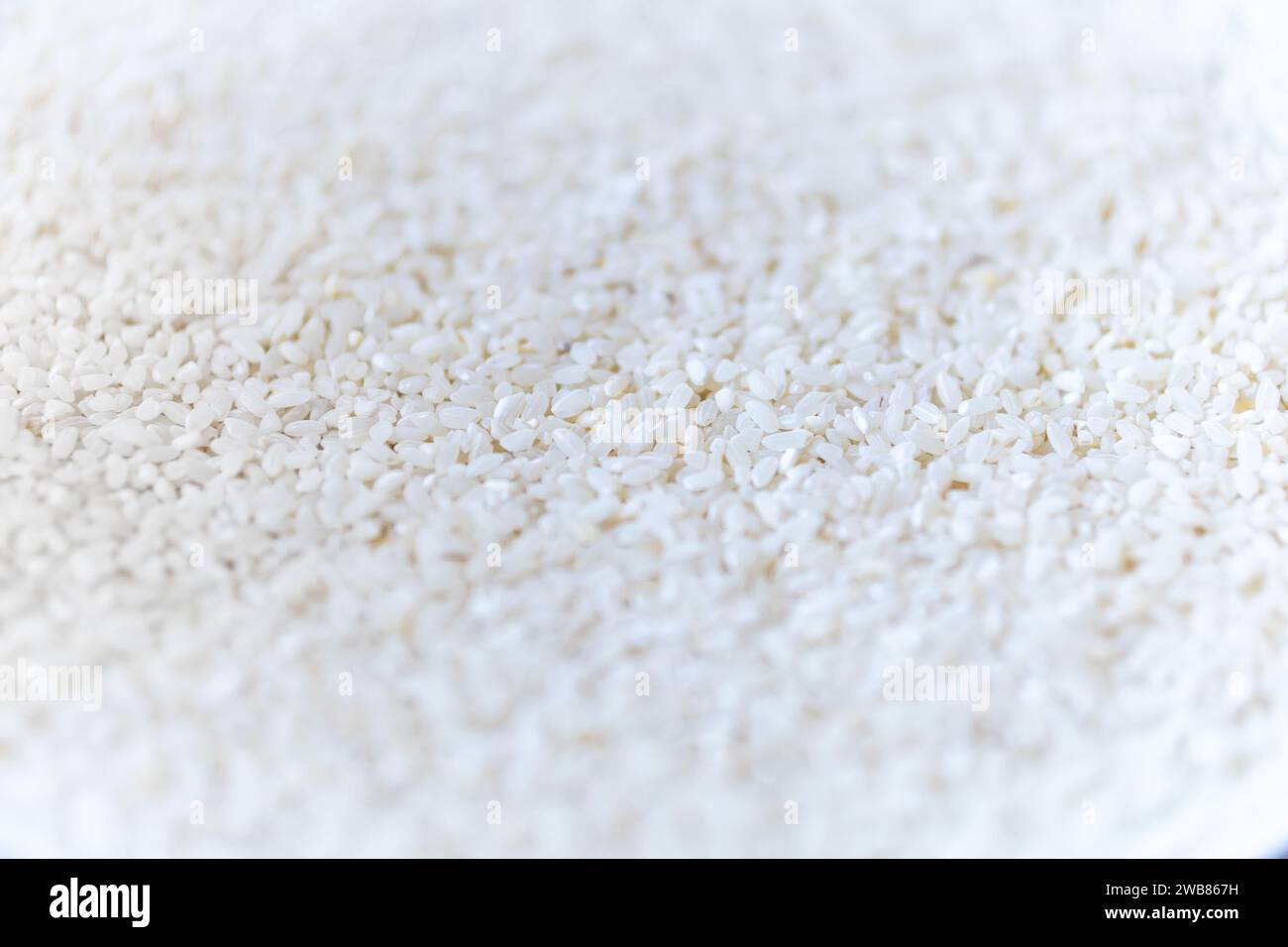 White long rice background, uncooked raw cereals, macro, close up, low ...