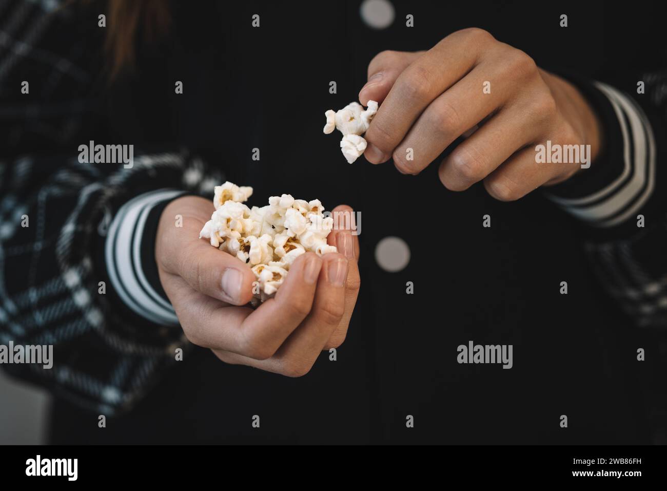 close-up of little girl hand holding popcorn. close-up of popcorn in ...