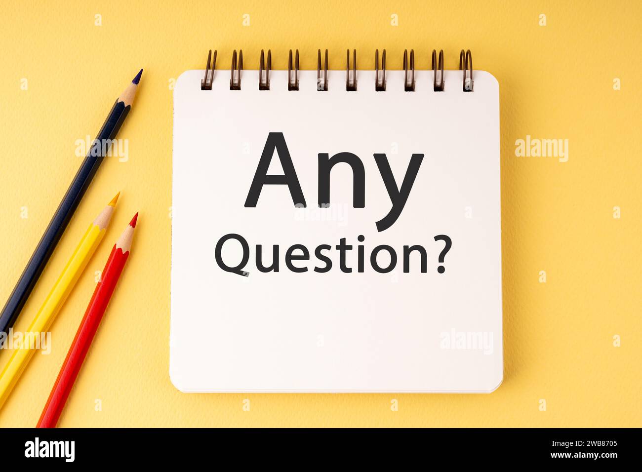 Notepad with text Any Question? on yellow background Stock Photo - Alamy