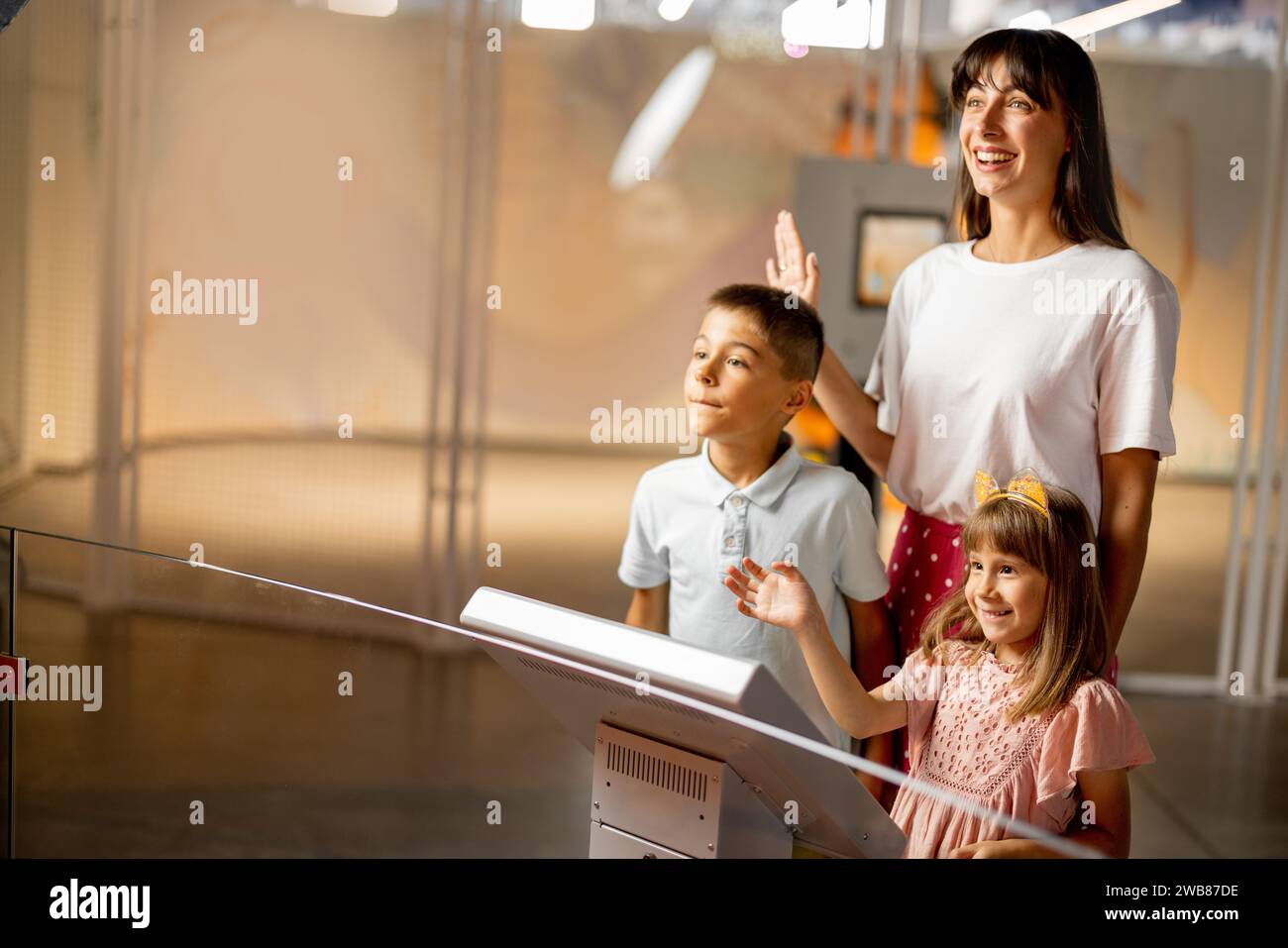 Mom with a kids interact with robot in science museum Stock Photo - Alamy
