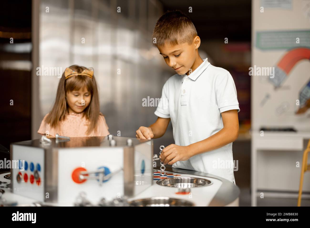 Kids play with magnets in science museum Stock Photo - Alamy