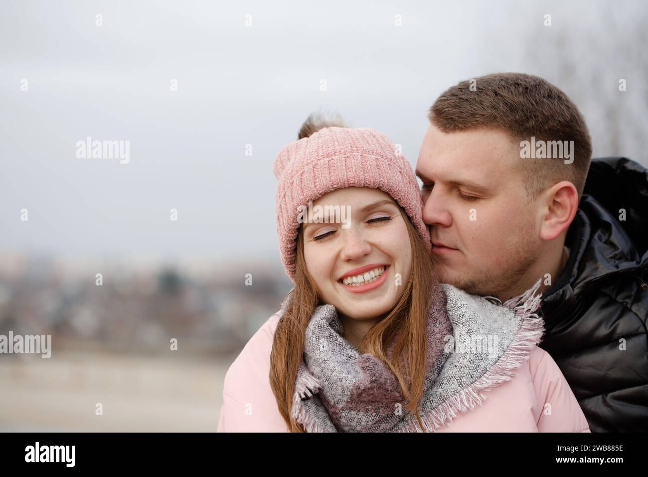 Portrait of a young happy couple outside on a walk. Valentine's day ...
