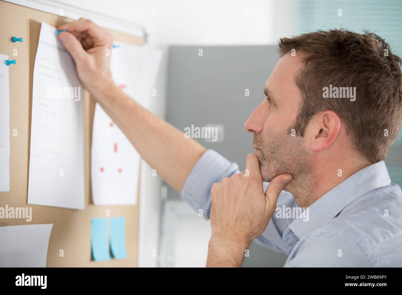 male interior designer with project plan in office Stock Photo - Alamy