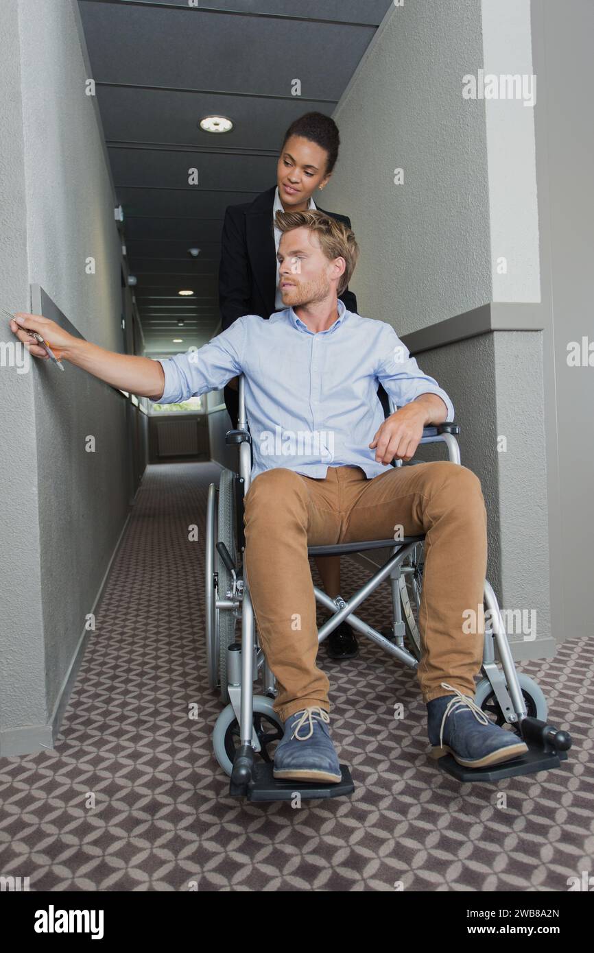 man in a wheelchair being pushed to his room Stock Photo - Alamy