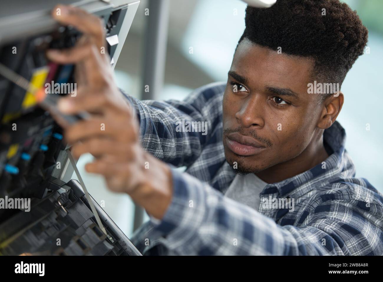 man repairing a professional photocopier Stock Photo - Alamy