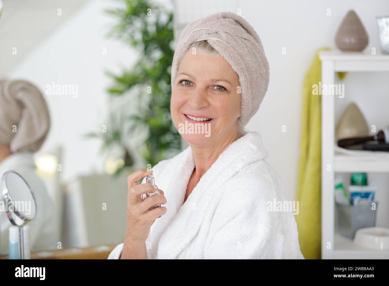 cheerful senior woman applying perfume after her shower Stock Photo - Alamy