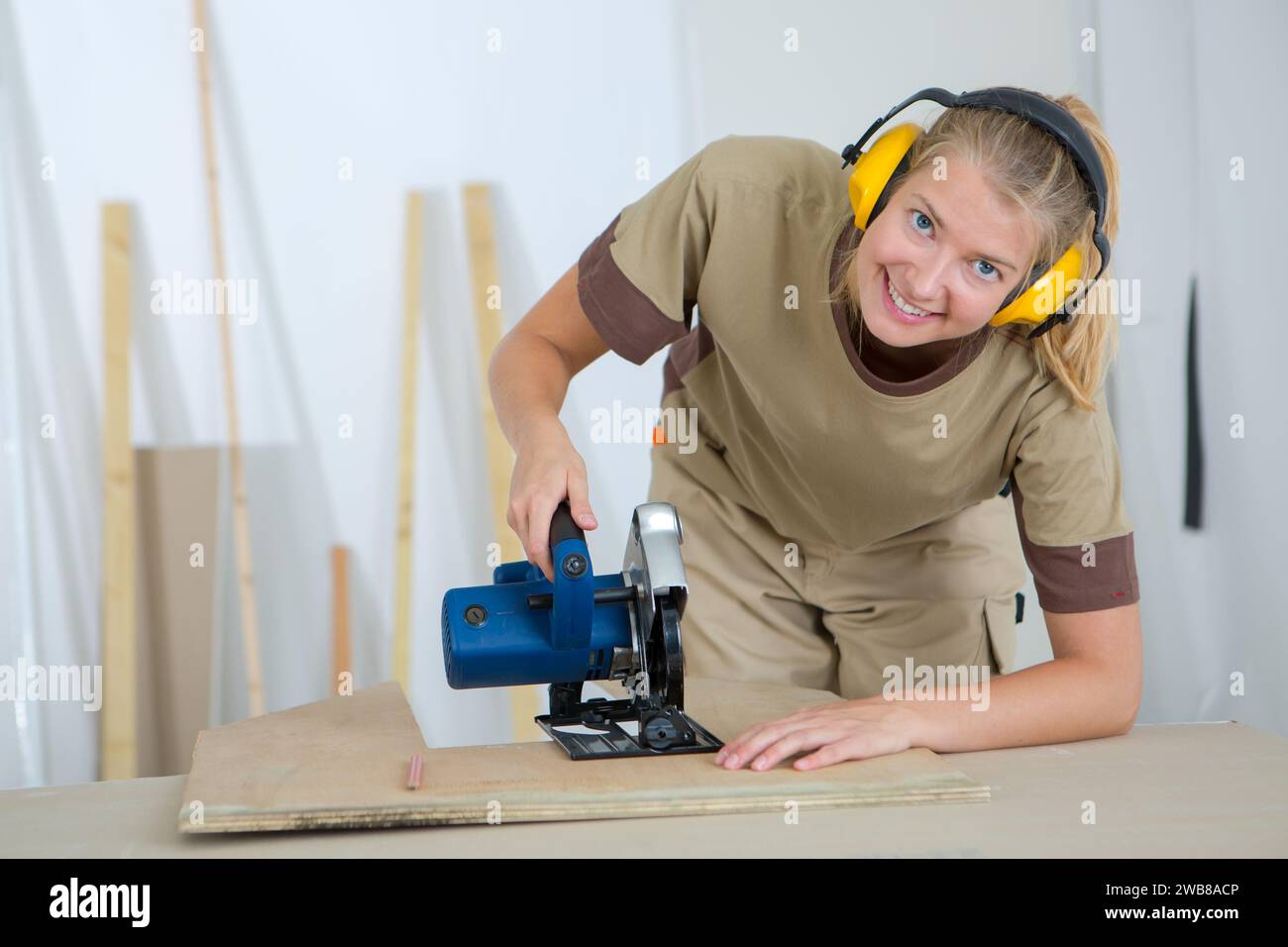 Woman using electric saw hi-res stock photography and images - Alamy