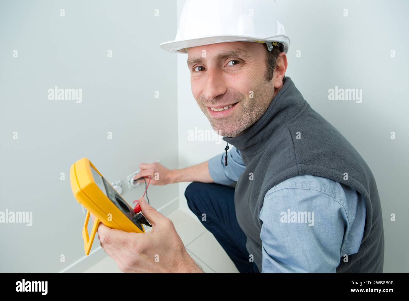 electrician measuring voltage of socket indoors Stock Photo - Alamy