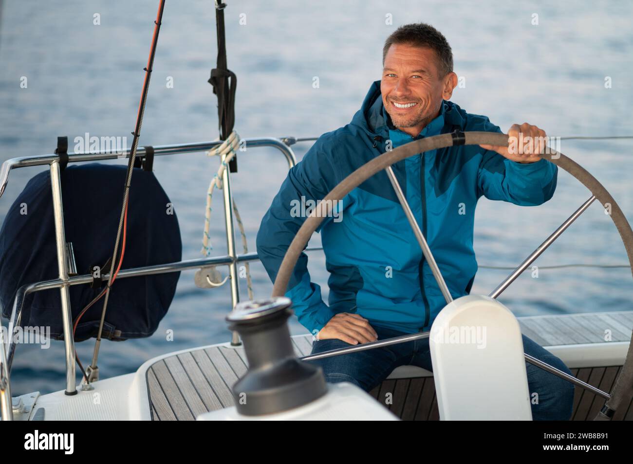 Smiling mature man sailing a ship Stock Photo - Alamy