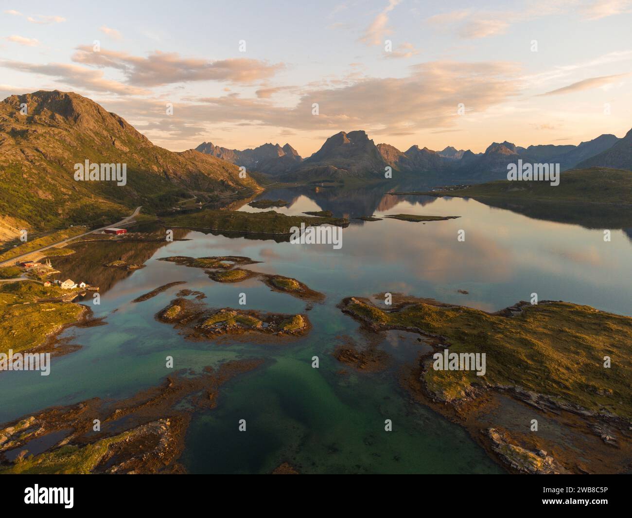 Aerial view of a fjord in Lofoten, Norway with a beautiful sunset over ...