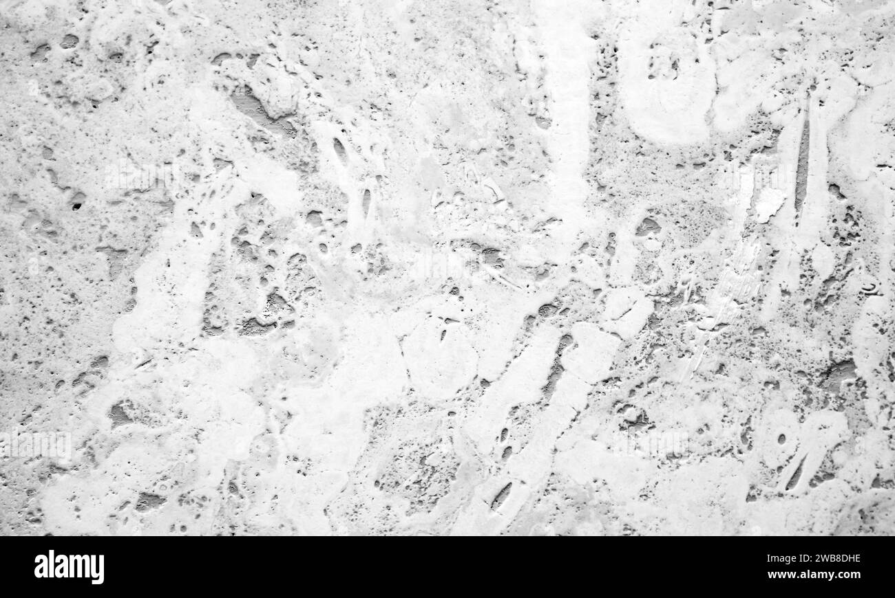 White wall with decorative relief plaster pattern, frontal view ...