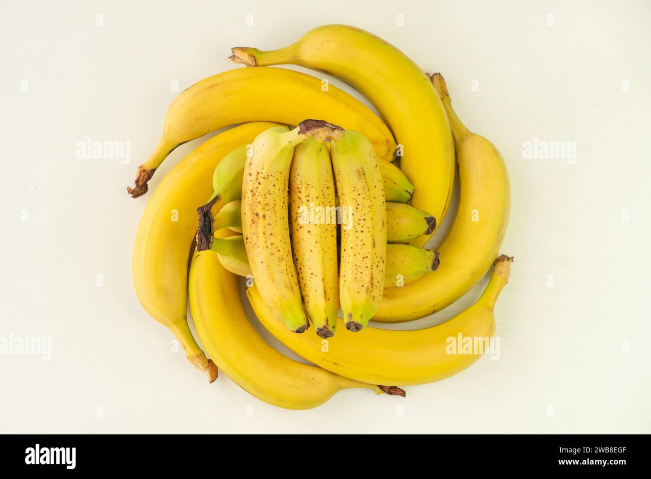 Bananas folded in the shape of a circle lie on white background of the ...