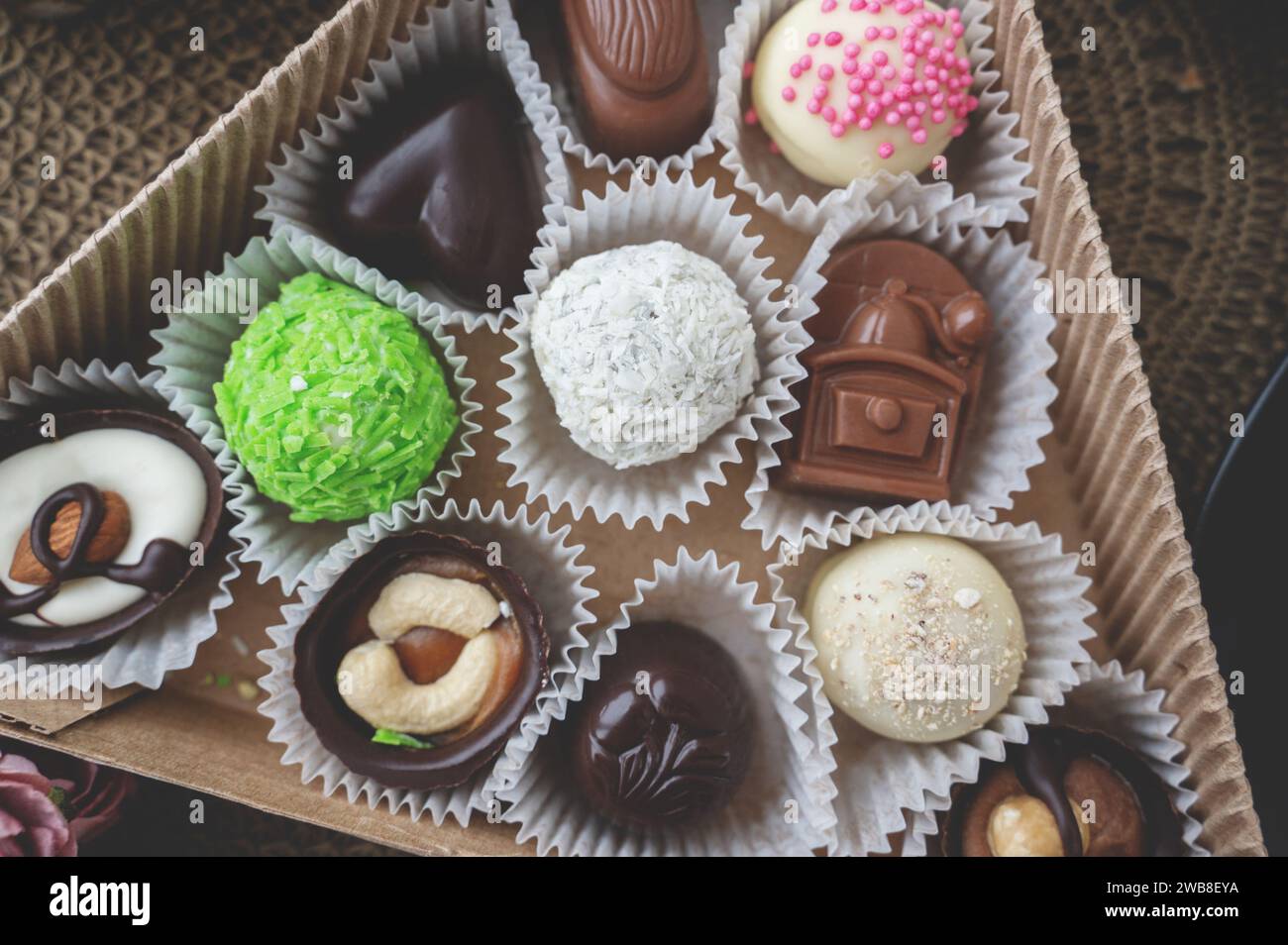 Handmade candy. White and dark chocolate with nuts in gift wrapping ...