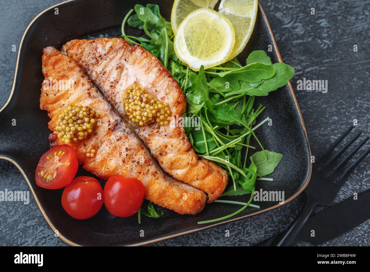 Grilled Butterfly salmon steak with cherry tomatoes and arugula salad ...