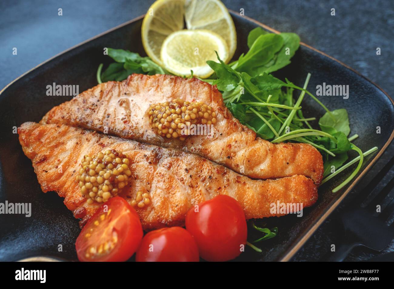 Grilled Butterfly salmon steak with cherry tomatoes and arugula salad ...