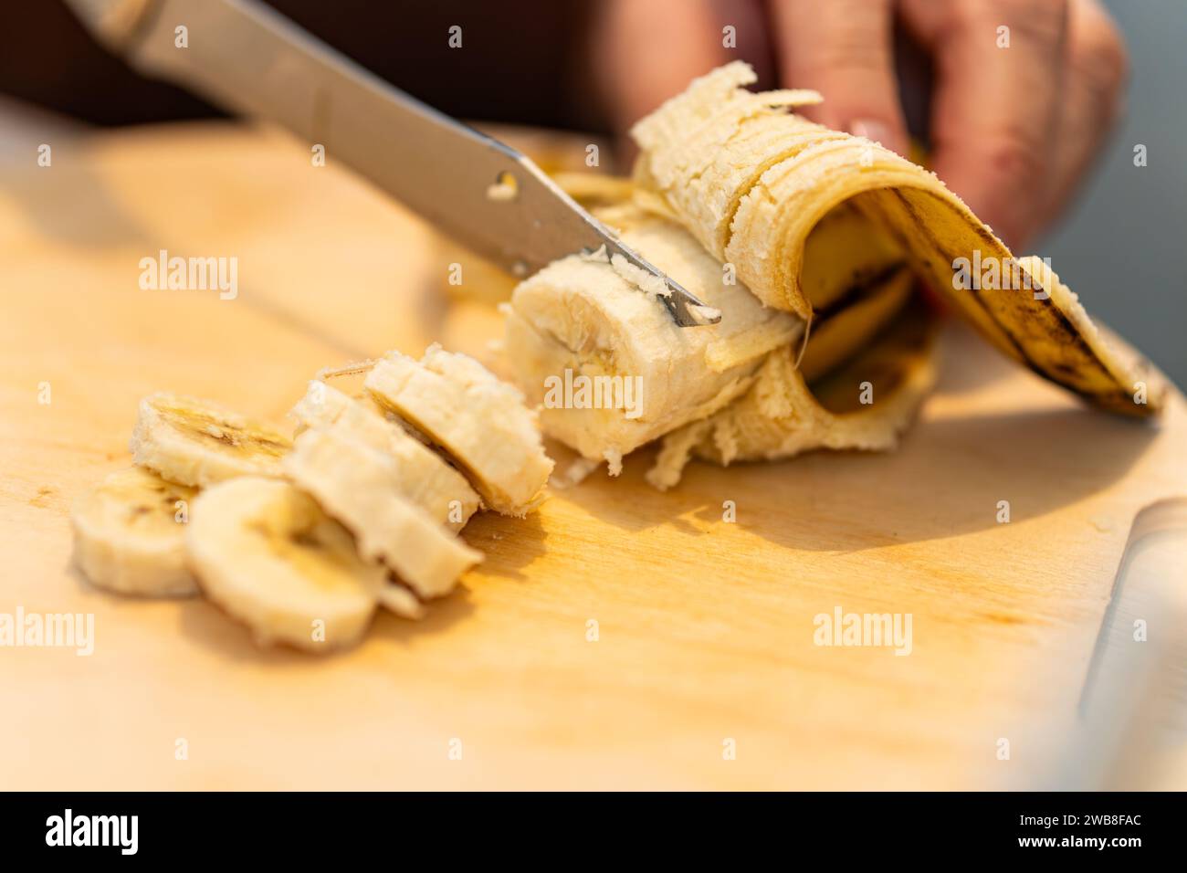 Woman cutting banana hi-res stock photography and images - Alamy