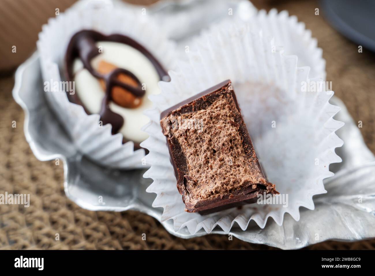 Handmade candy bitten off close-up on the table. Handmade chocolate ...