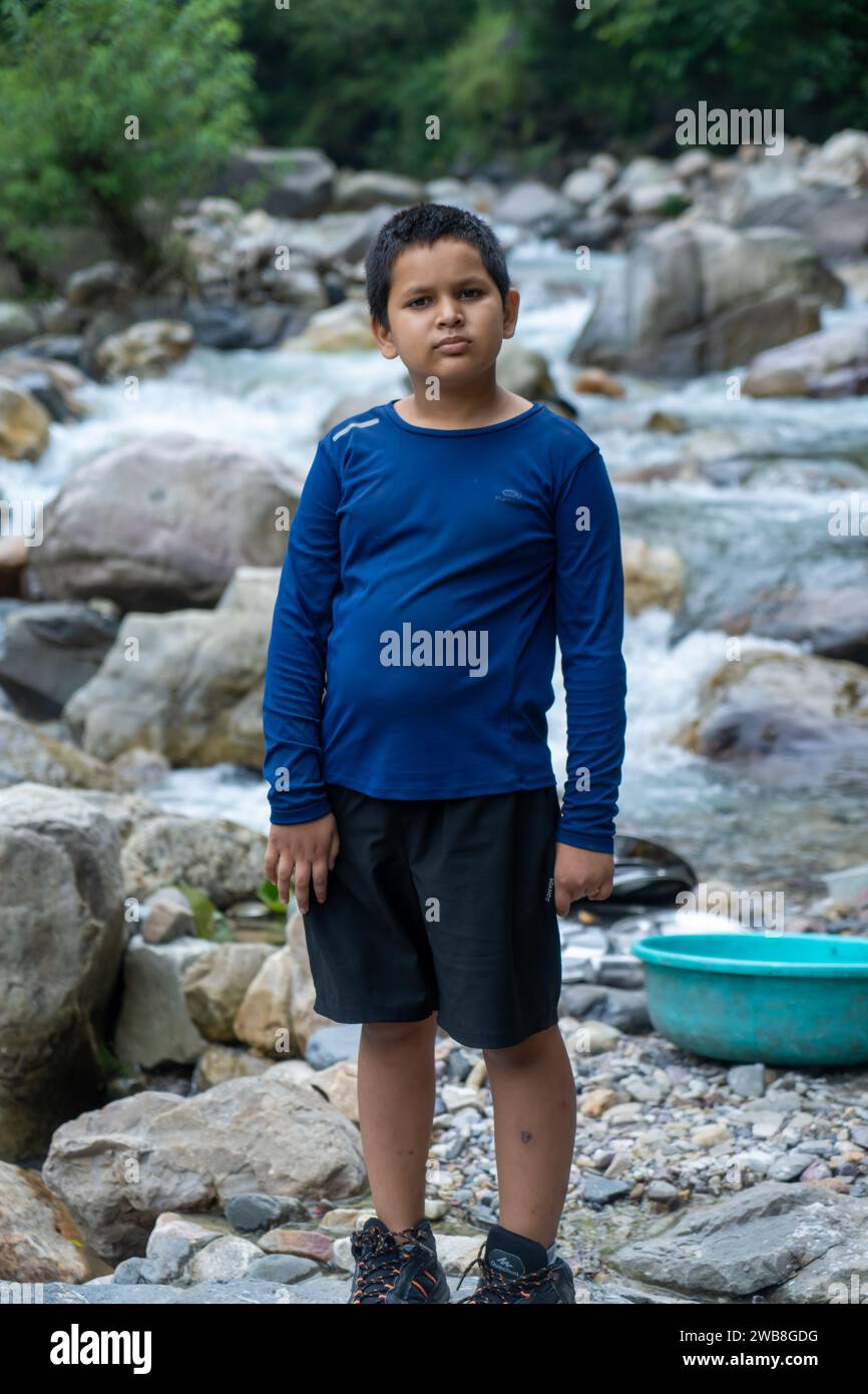 A boy stands, absorbing the rhythm of nature's timeless flow Stock ...