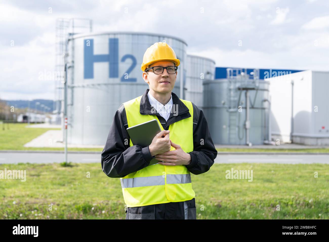 Engineer with tablet computer on a background of Hydrogen factory Stock ...