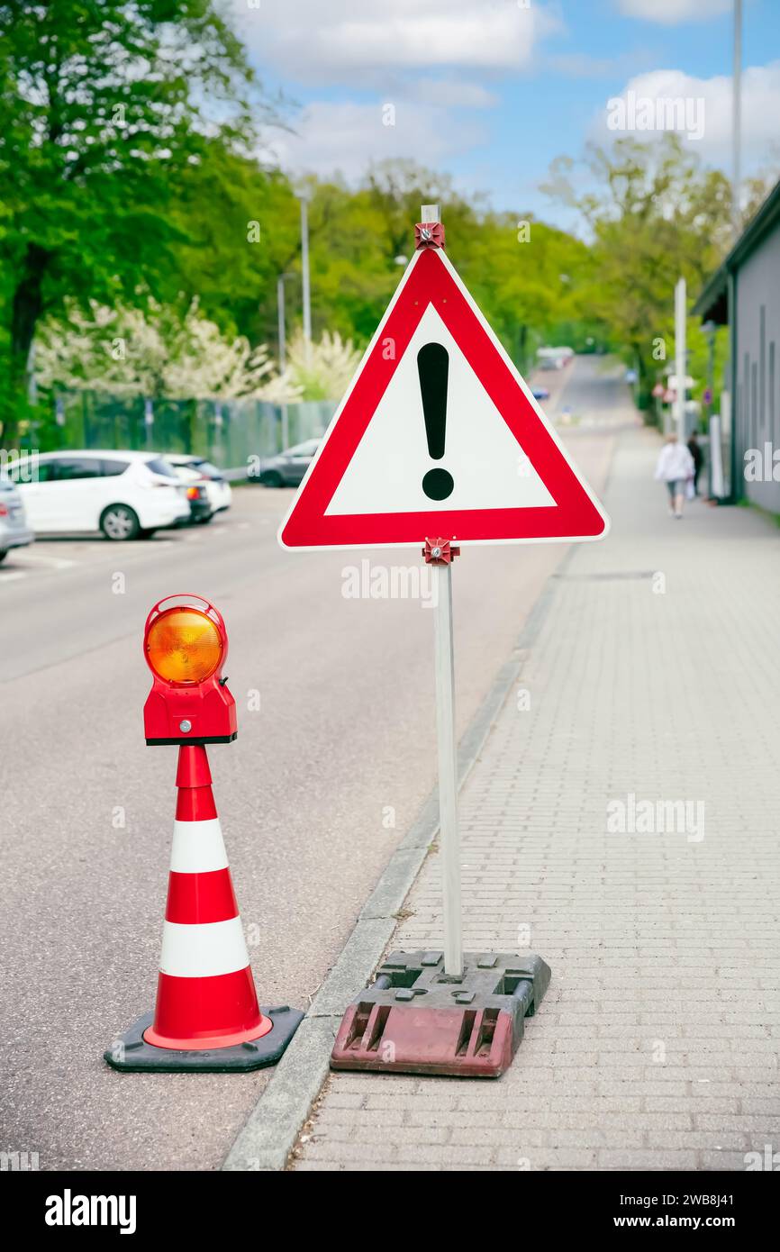 Traffic code with traffic sign danger point on a road, red exclamation ...
