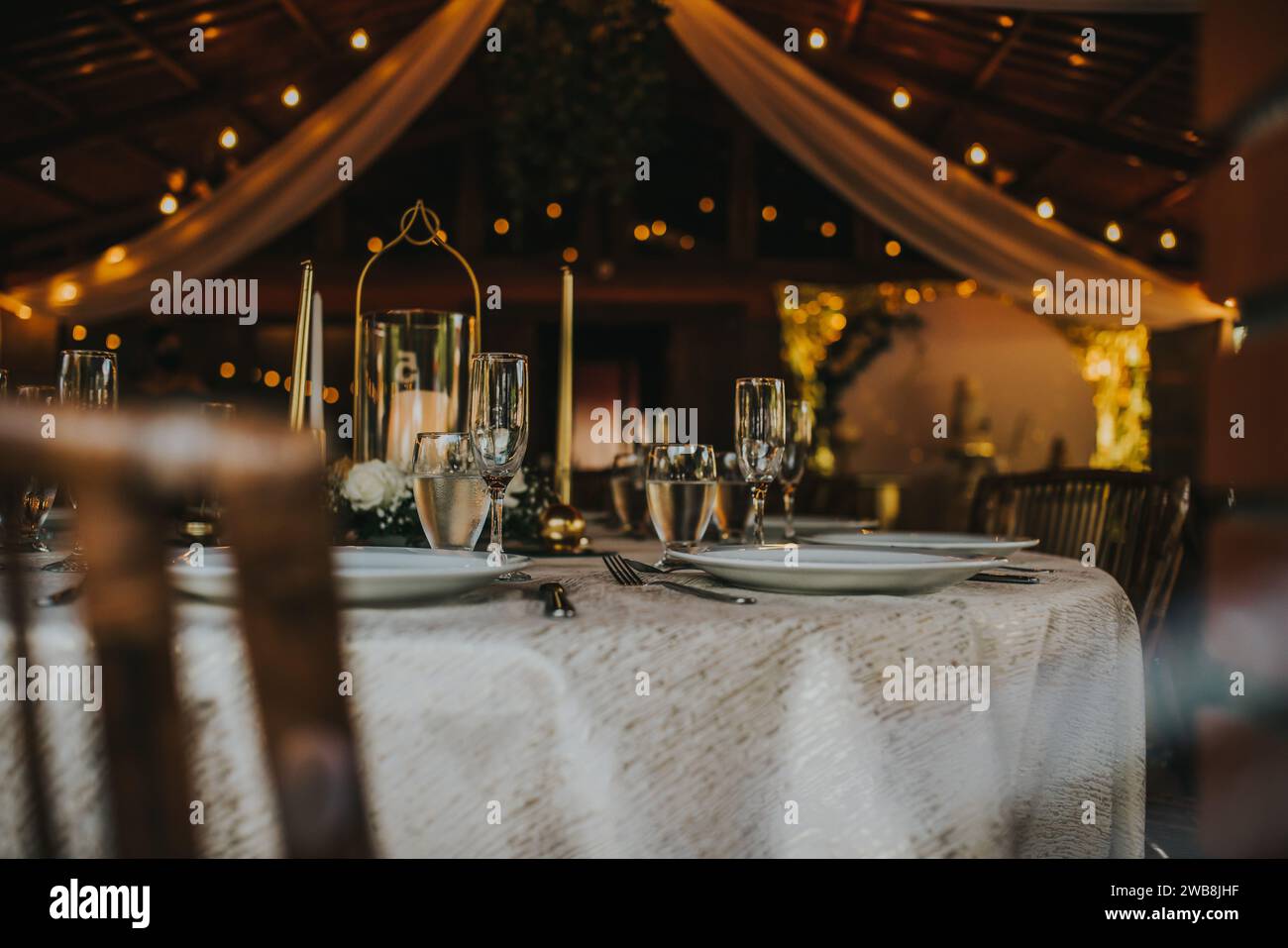 An elegantly decorated dining table set up for a wedding dinner at a ...