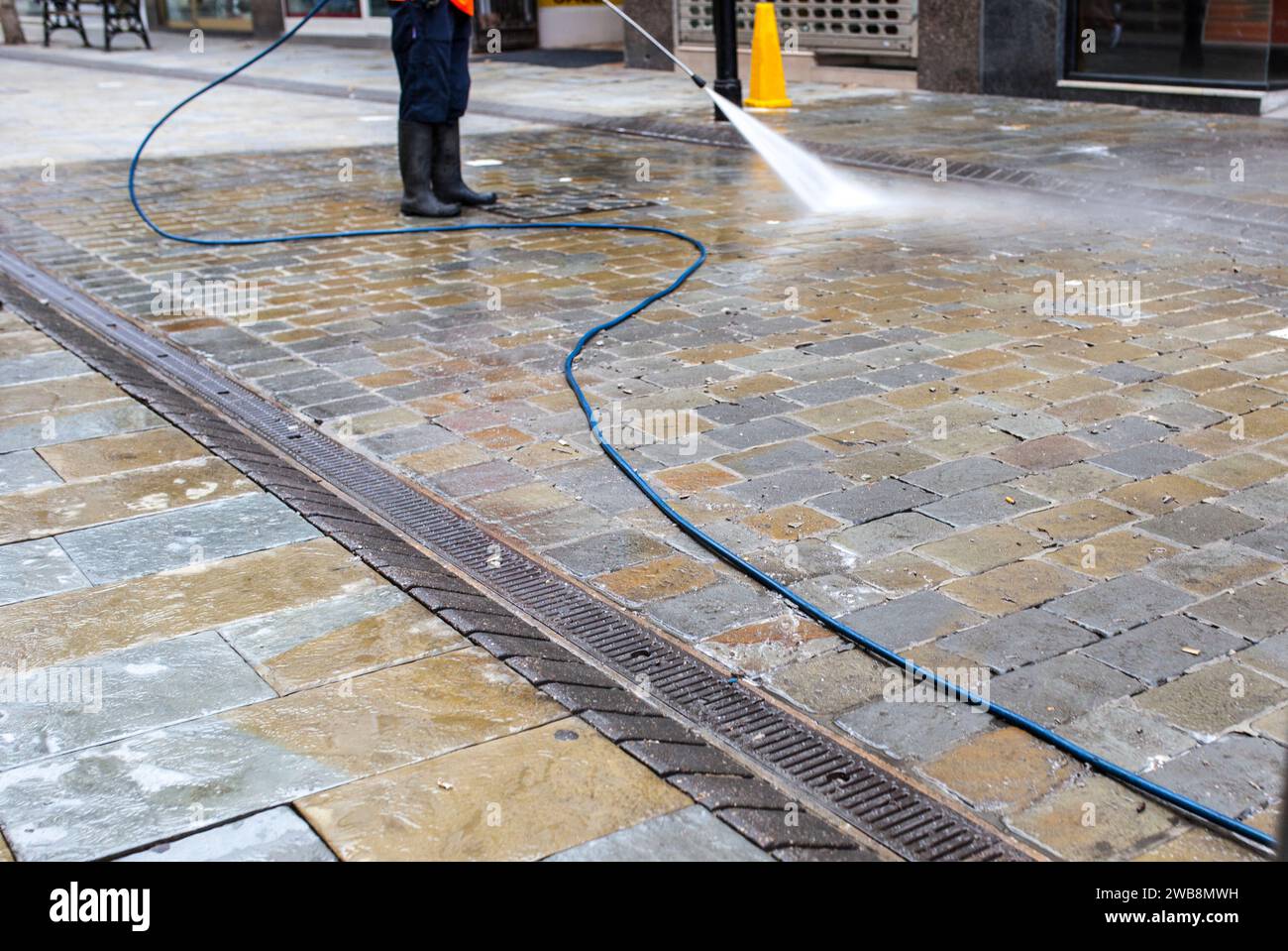 Urban cleaning service operator with high pressure gun. Selective focus ...