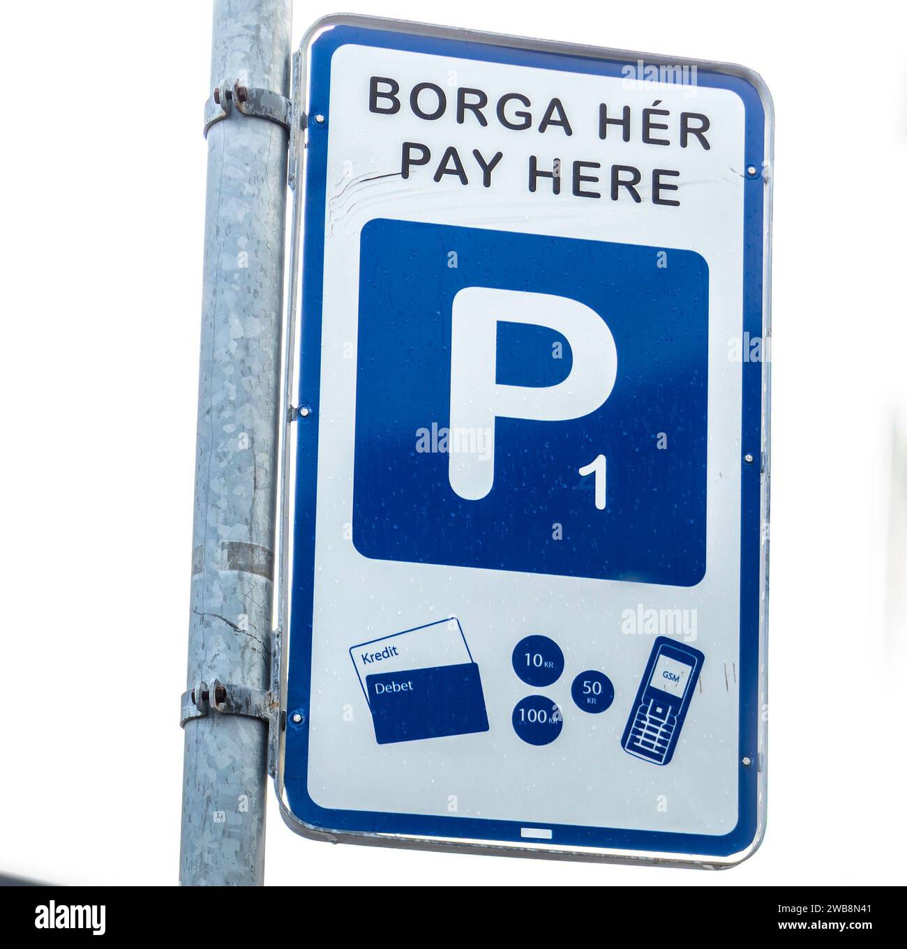 Parking sign in Reykjavik, Iceland. Shows directions for payment, with ...