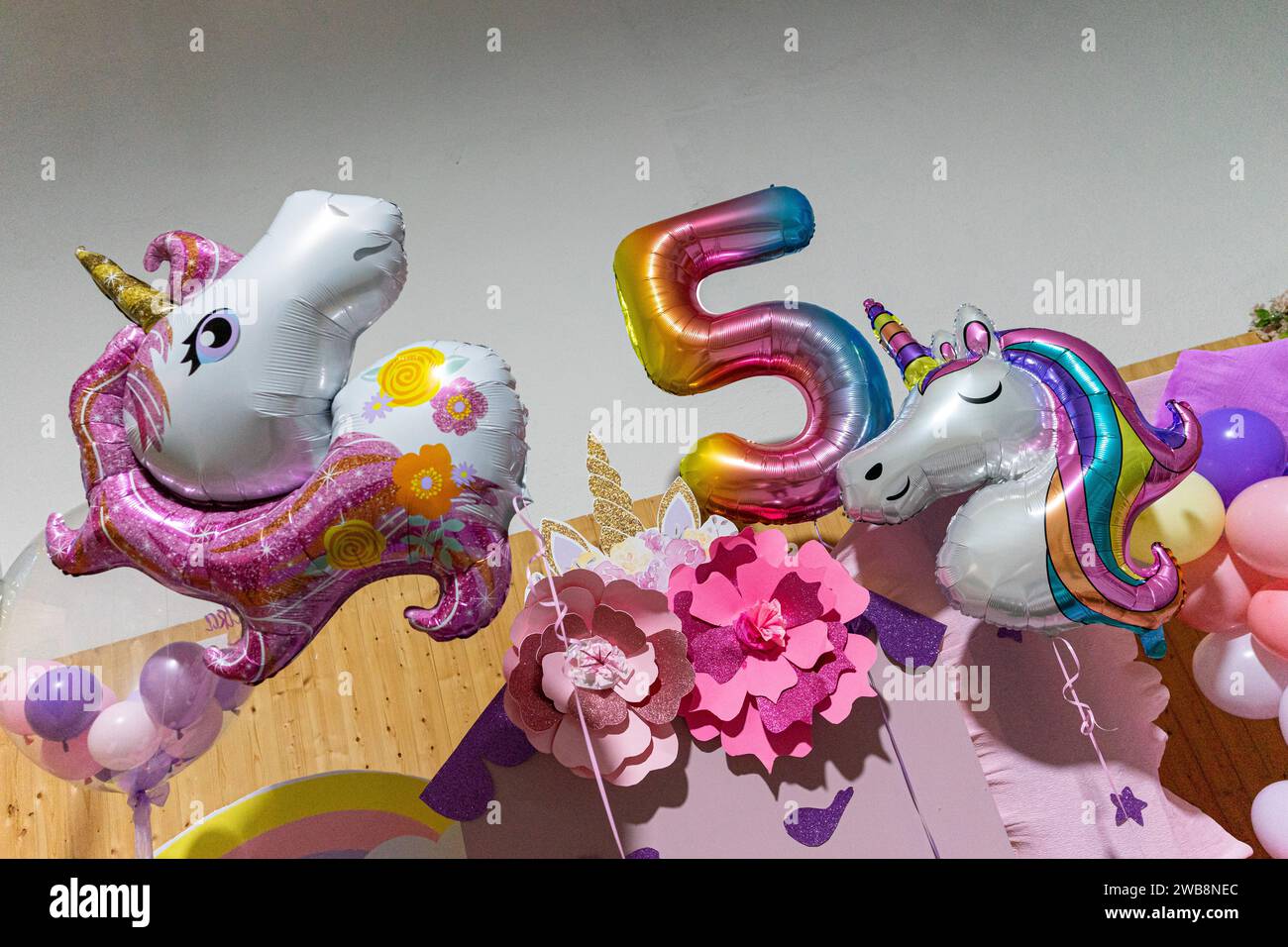 Colorful unicorn-shaped balloons and a '5' balloon at a 5-year-old girl ...